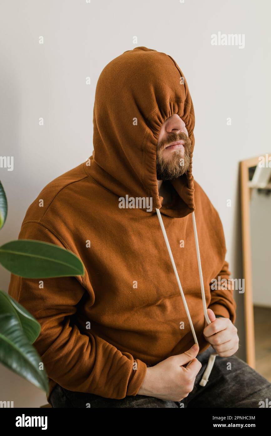 Depressed unhappy man covered hood her face - escapism and loneliness ...