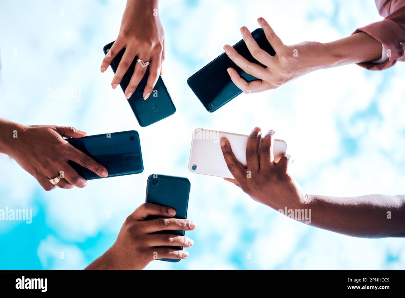 Connection, below and hands with phone on a blue sky for social network ...