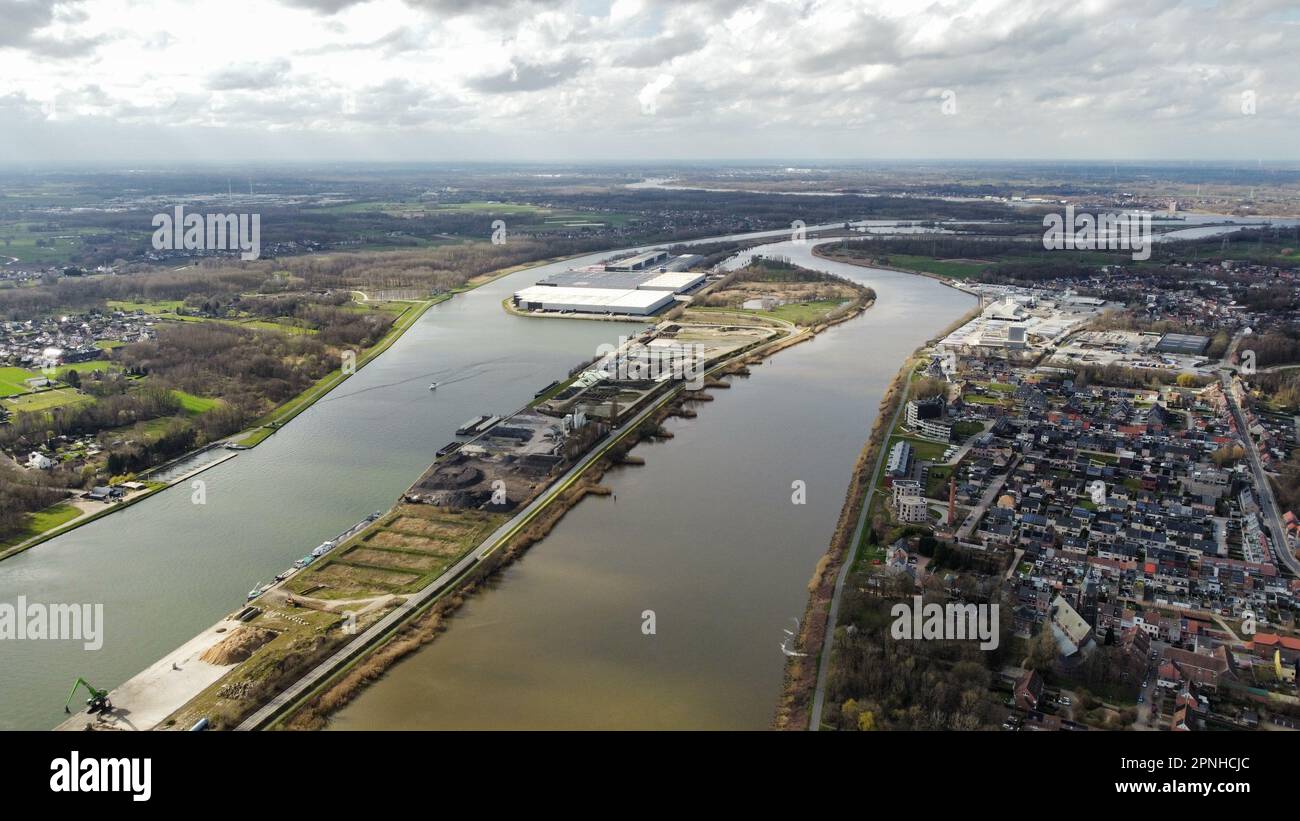 A tranquil aerial view of a large body of water alongside a sprawling ...