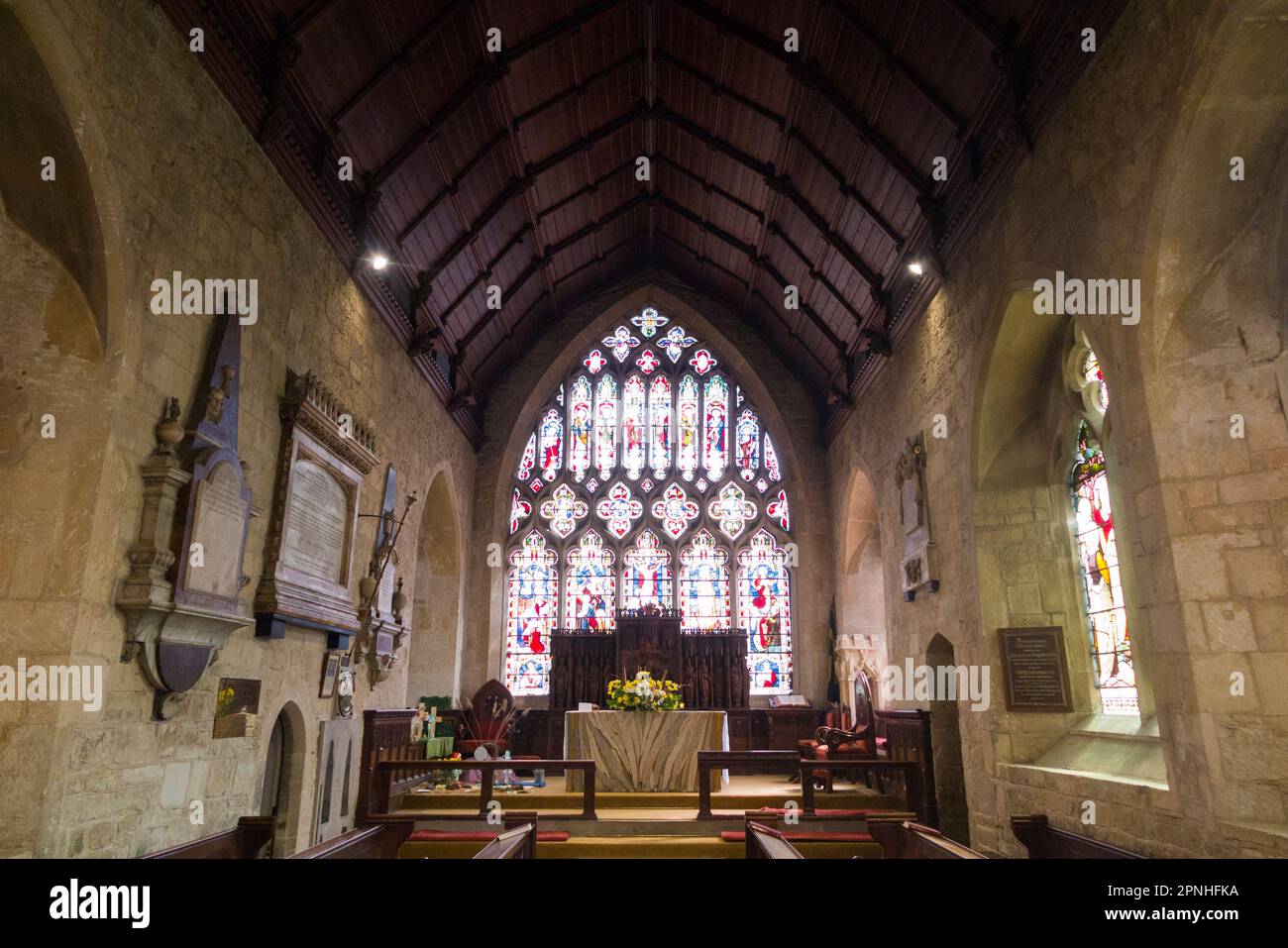 Stained glass church window overlooking the High Table beyond old choir ...