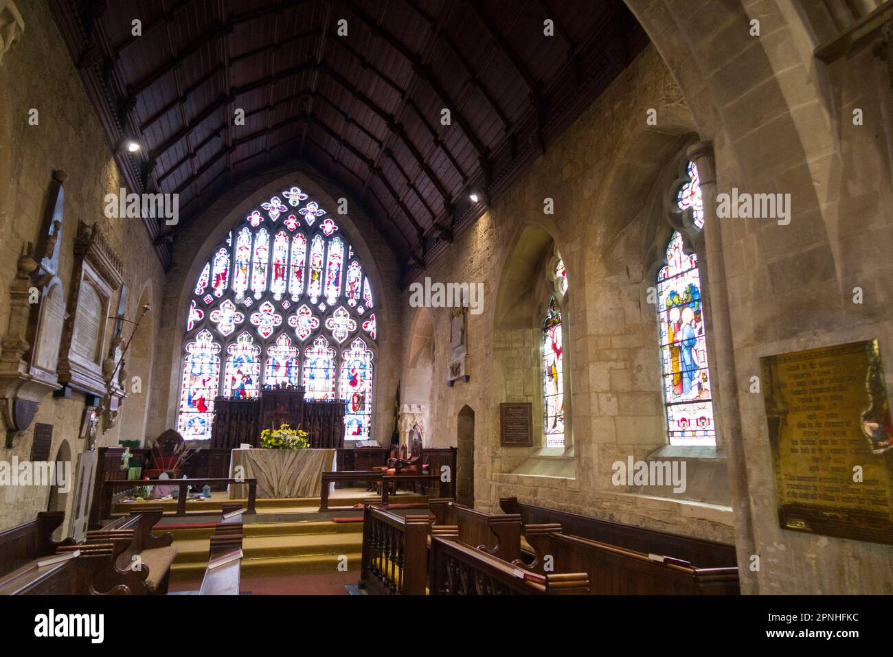 Stained glass church window overlooking the High Table beyond old choir ...