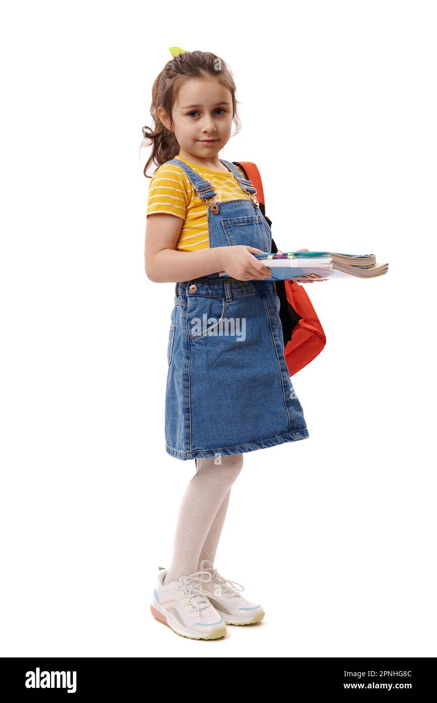 Caucasian smiling excellent student, first grader schoolgirl, holding ...