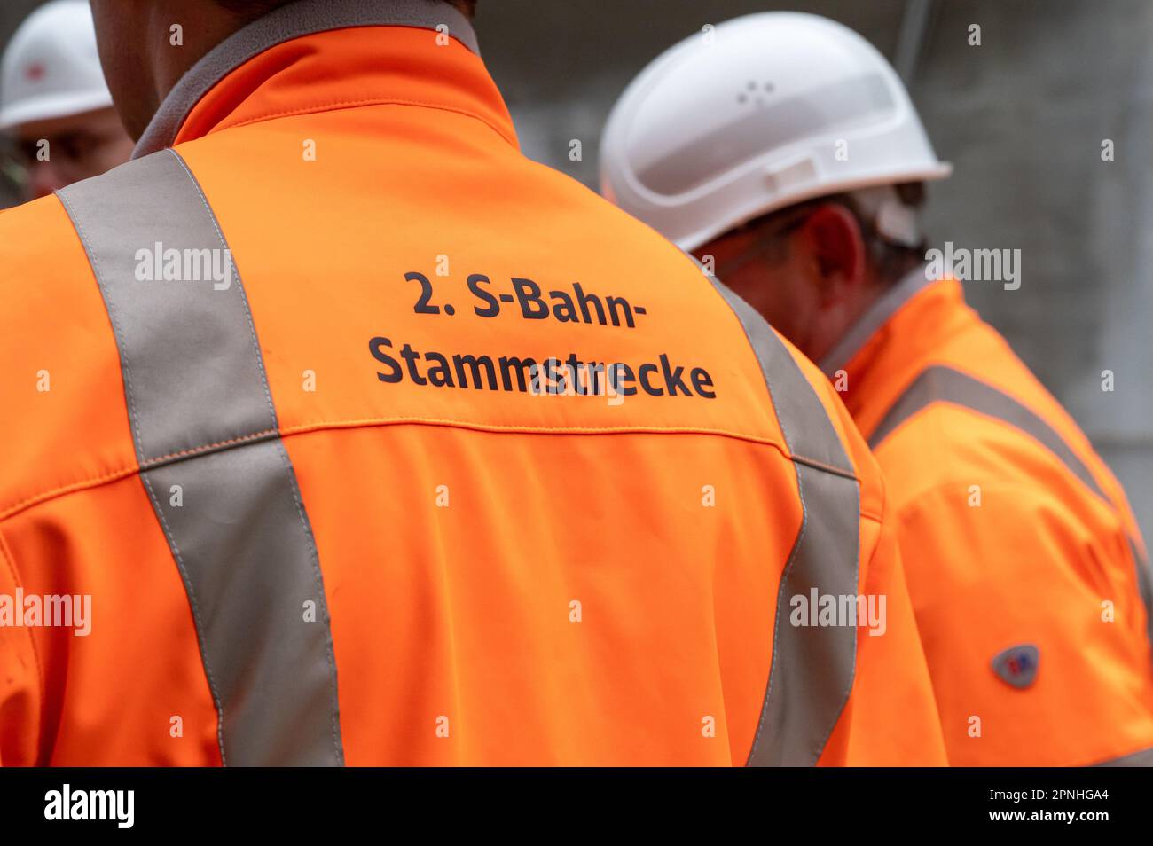 Munich, Germany. 19th Apr, 2023. Workers stand on the construction site ...