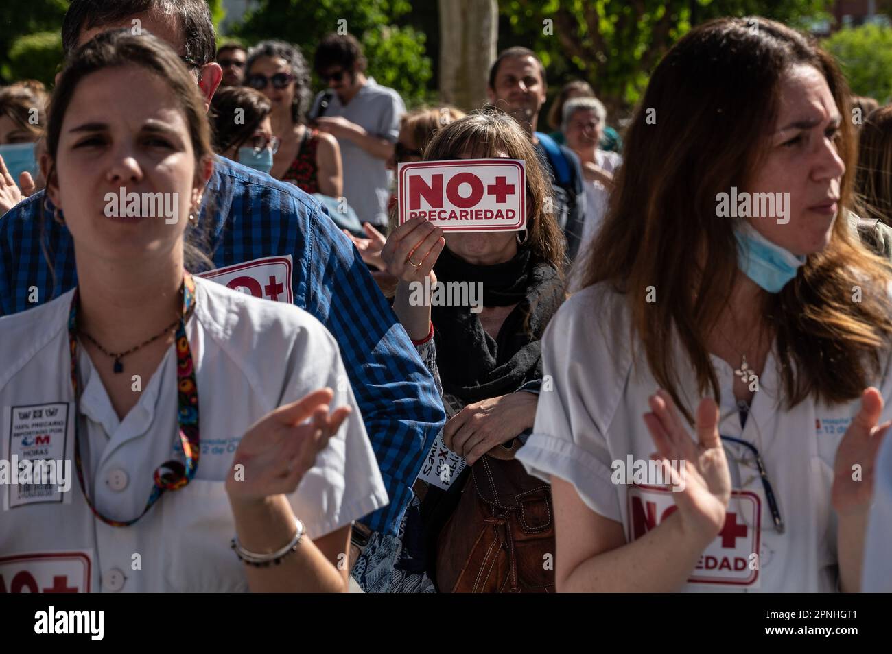 Madrid, Spain. 19th Apr, 2023. A woman holds a sticker with the words ...