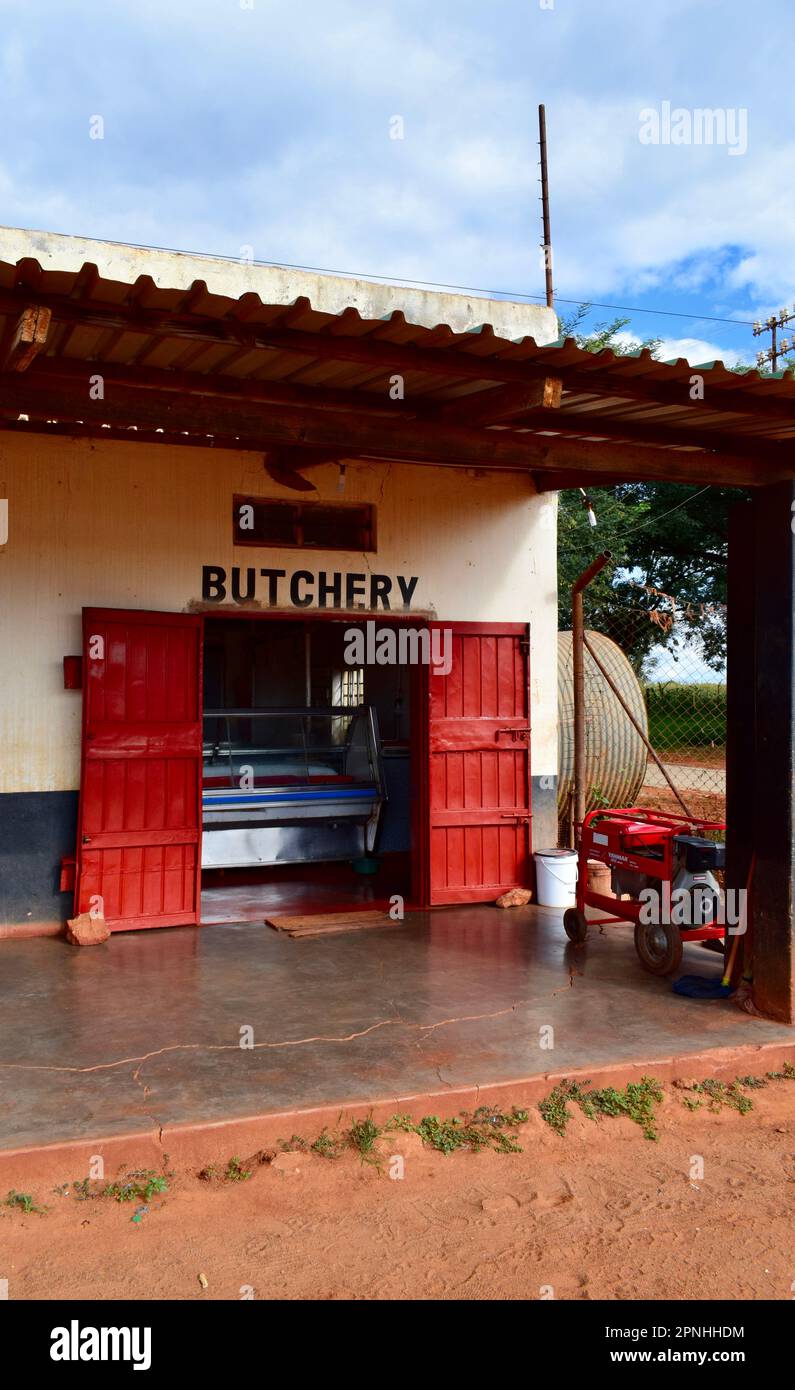 Butcher shop with red door in Africa Stock Photo - Alamy