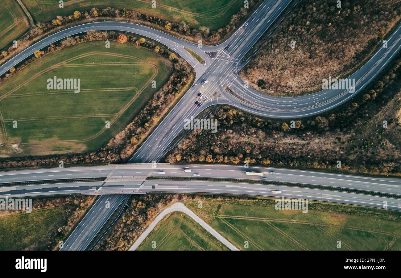 An aerial top view of a busy intersection of multiple highways criss ...