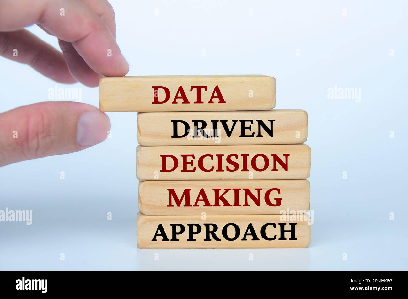Hand holding wooden block with text Data Driven Decision Making ...