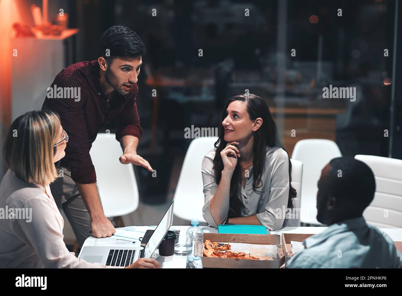 Stay late and get that success. colleagues having a meeting during a ...