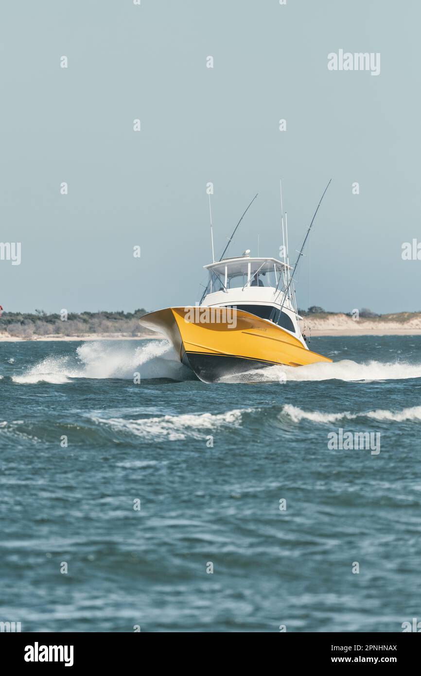 A large fishing vessel is seen navigating through the choppy waters of ...