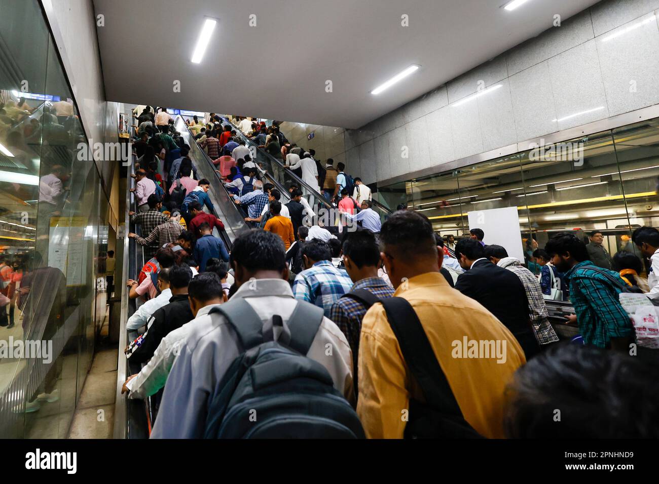 People going up on the escalator at Dilli Haat - INA metro station in ...