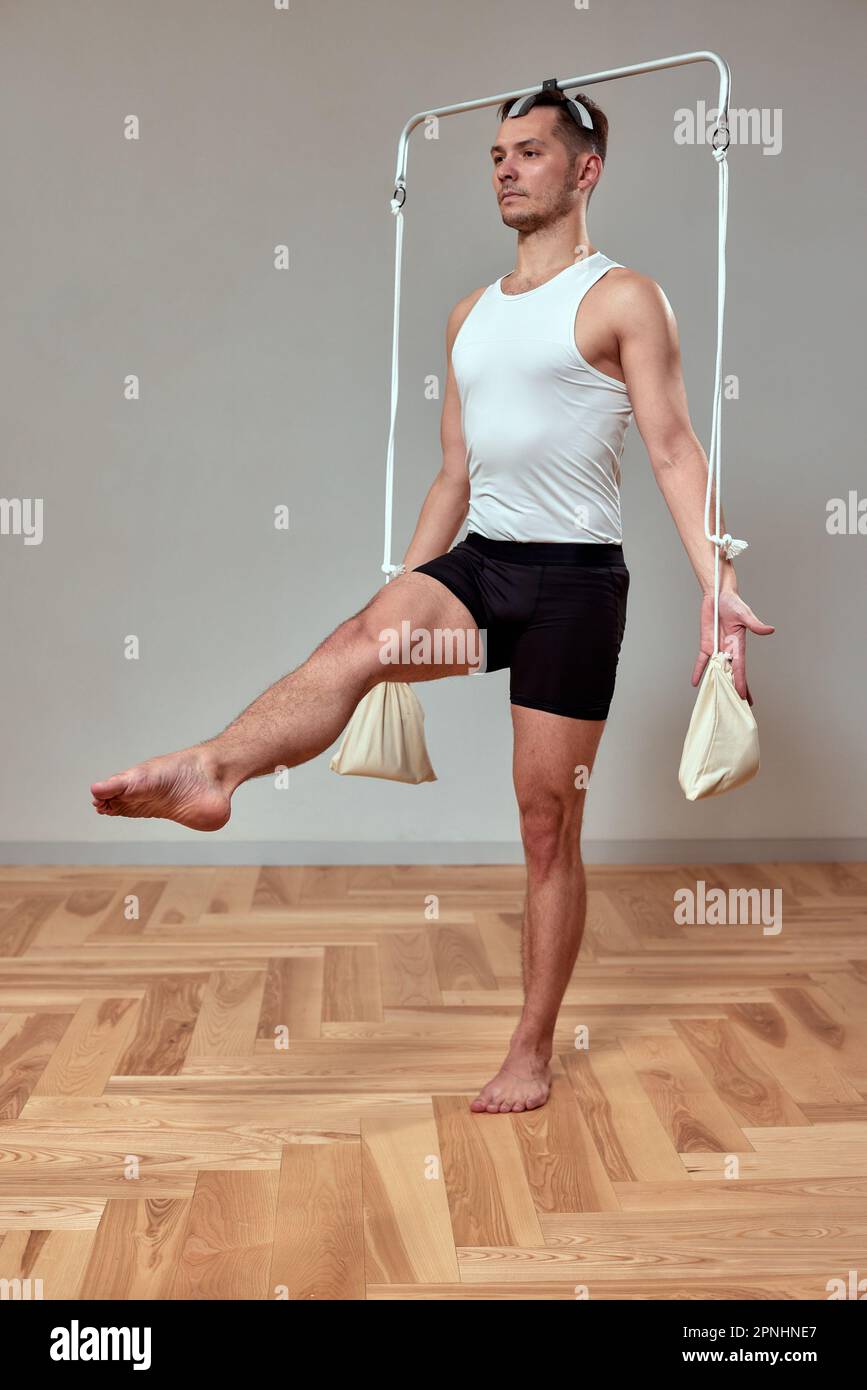 A man does exercises on a Pilates reformer, reformers for Pilates ...