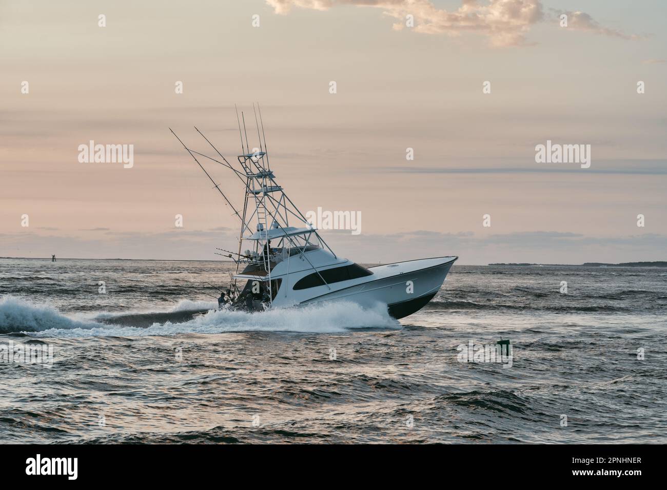 A large fishing vessel is seen navigating through the choppy waters of ...