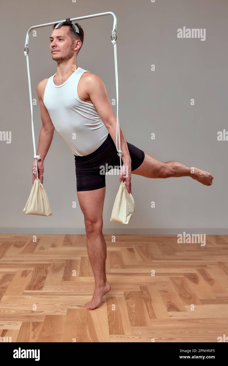 A man does exercises on a Pilates reformer, reformers for Pilates ...