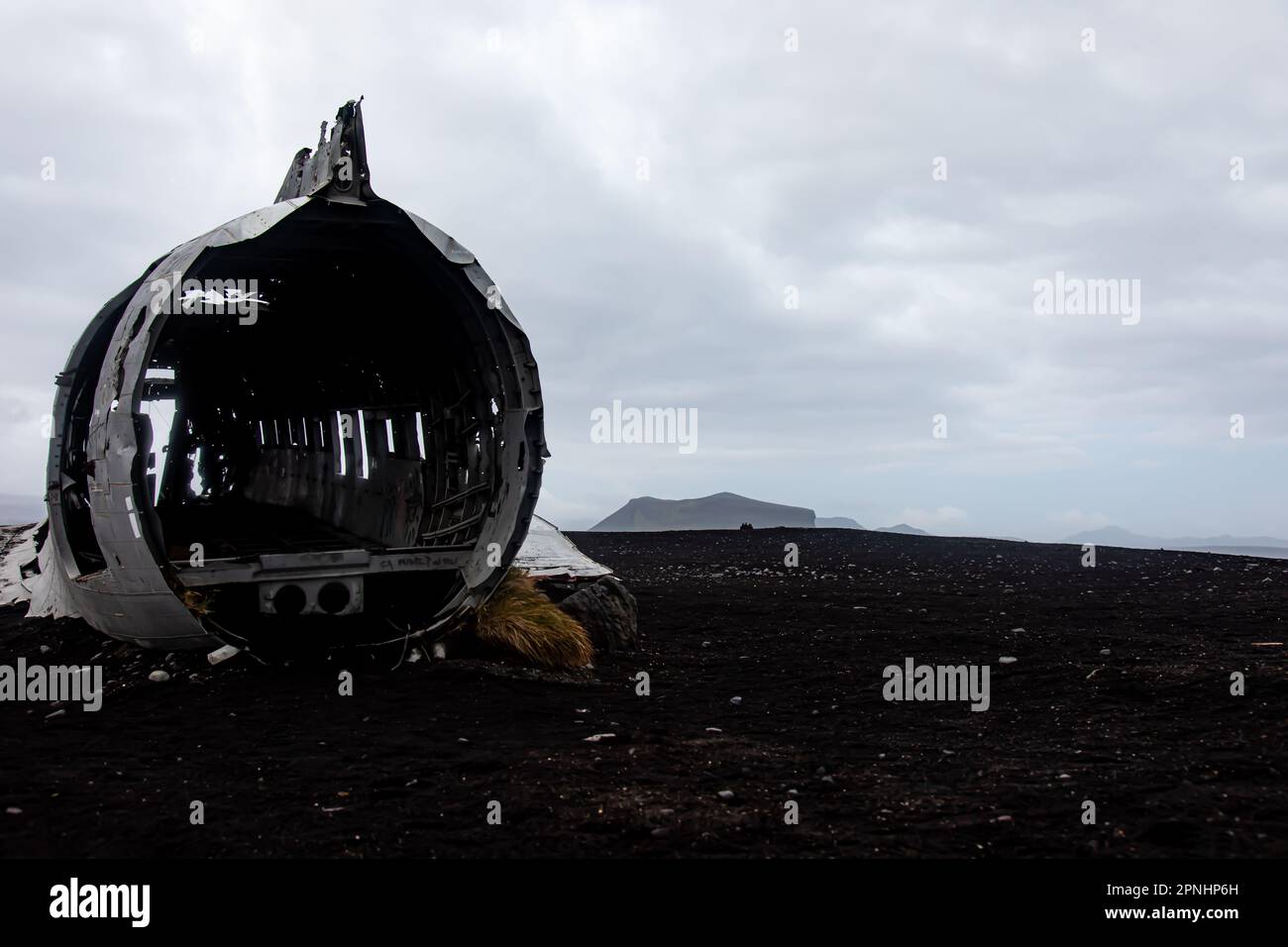 Sunset view of the old crashed plane wreck abandoned in a remoted black ...