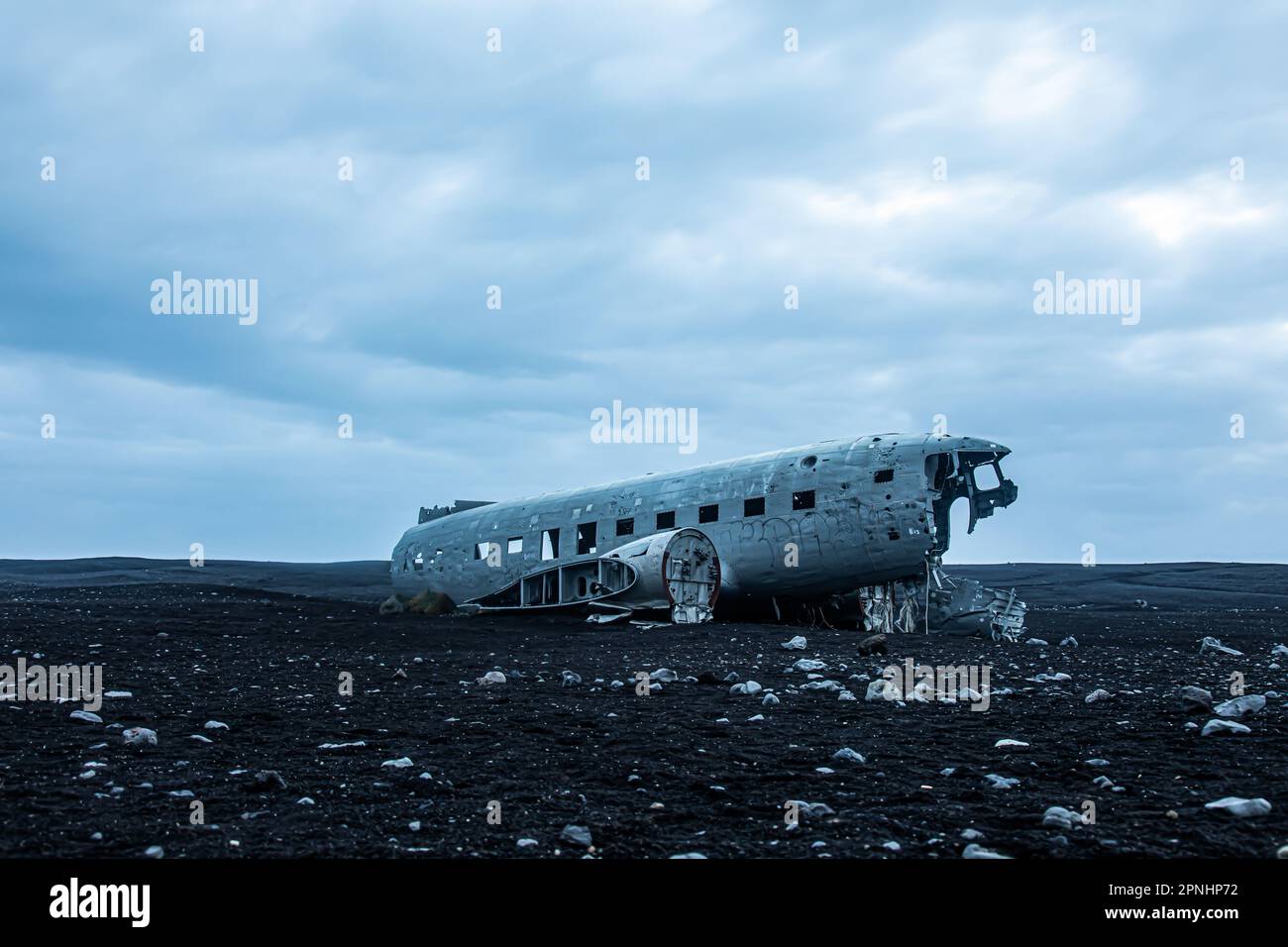 Sunset view of the old crashed plane wreck abandoned in a remoted black ...