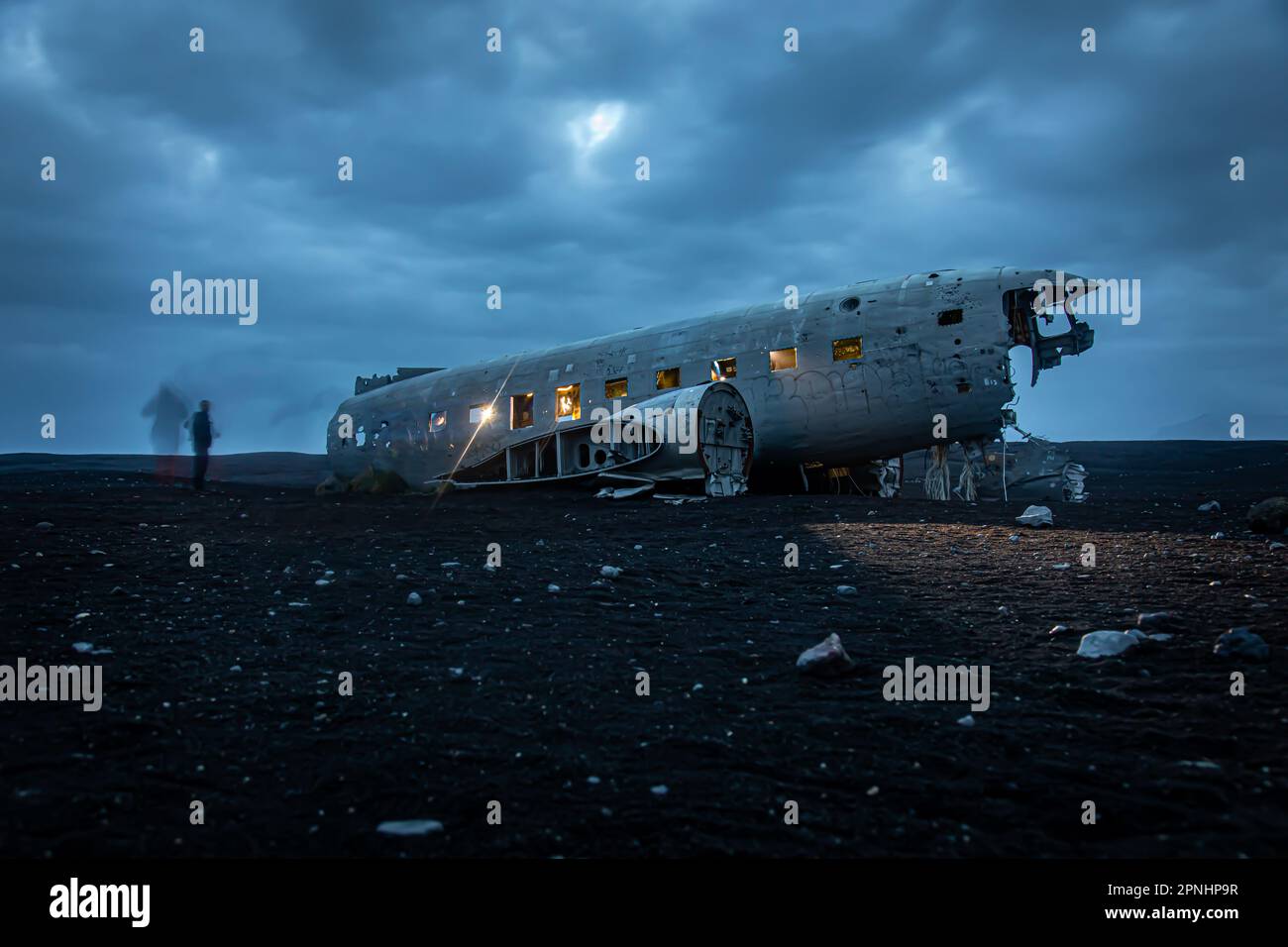 Night view of the old crashed plane wreck abandoned in a remoted black ...
