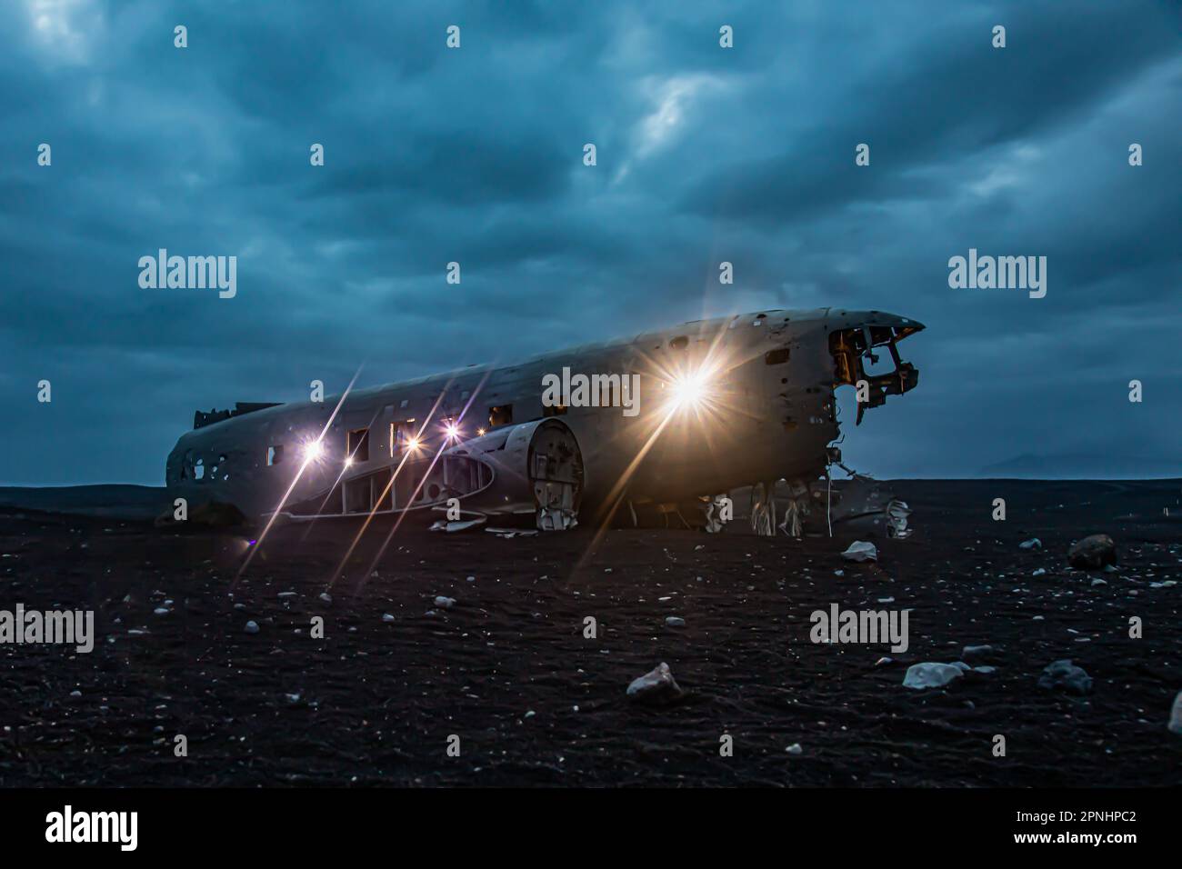 Night view of the old crashed plane wreck abandoned in a remoted black ...