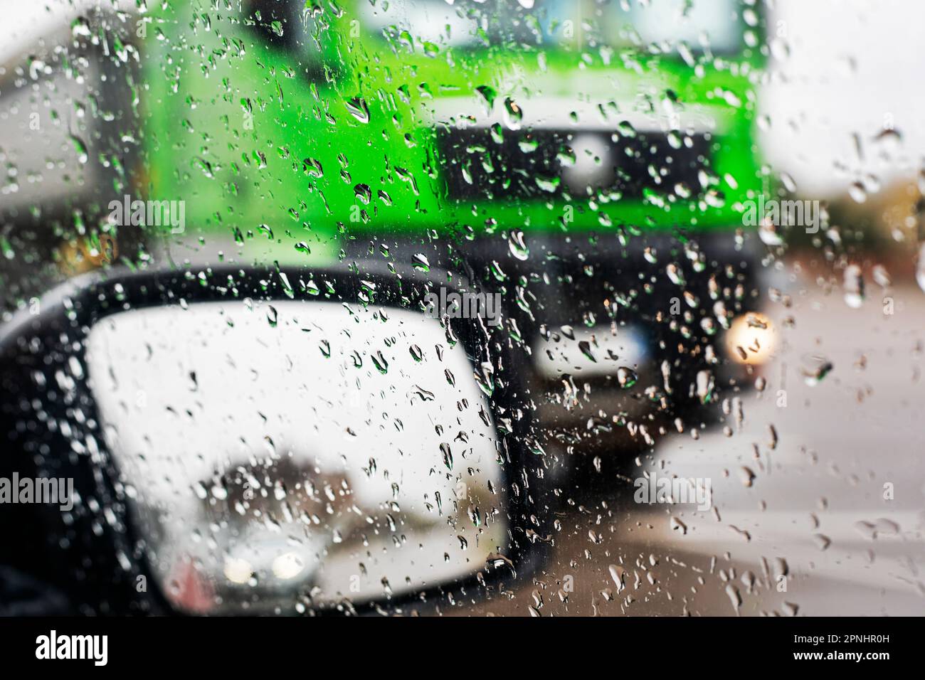 raindrops on the glass near the right mirror of the car, poor ...
