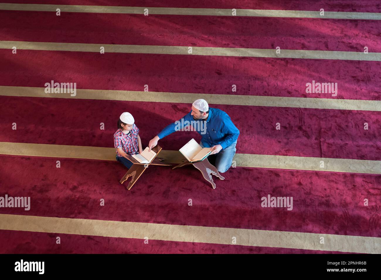 Muslim Man teaching his little son to pray to Allah and teachinh him ...
