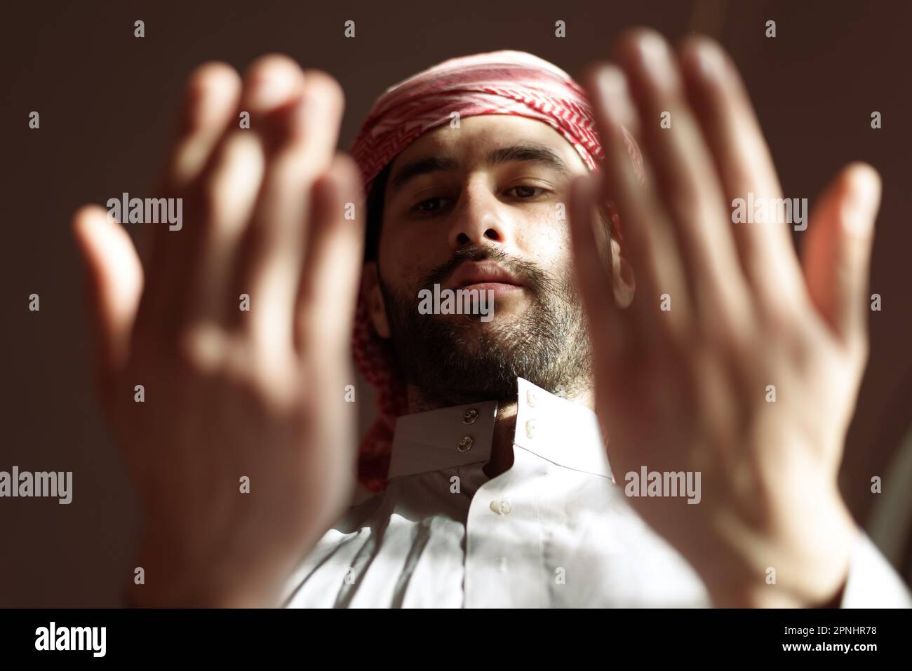 Arabic Muslim Man Making Traditional Prayer To God While Wearing ...