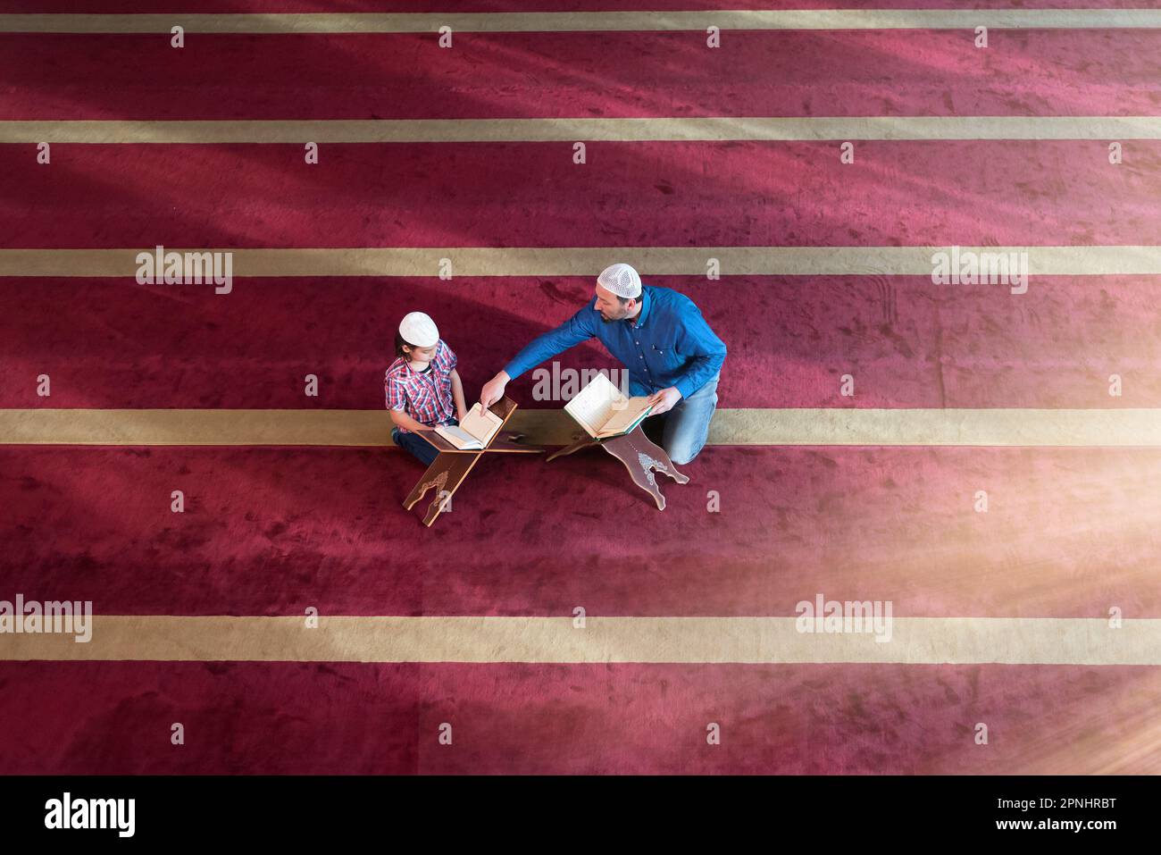 Muslim Man teaching his little son to pray to Allah and teachinh him ...
