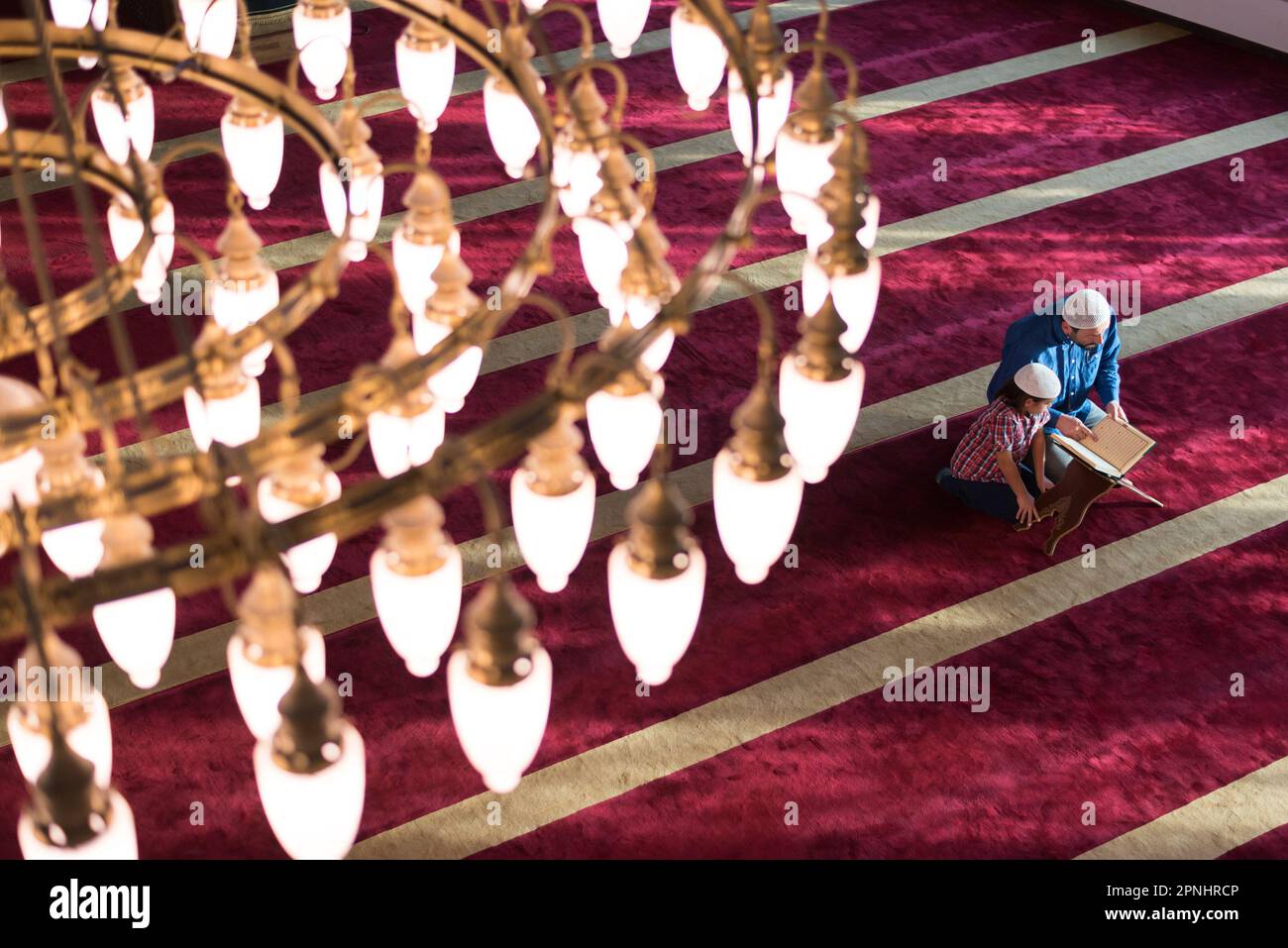 Muslim Man teaching his little son to pray to Allah and teachinh him ...
