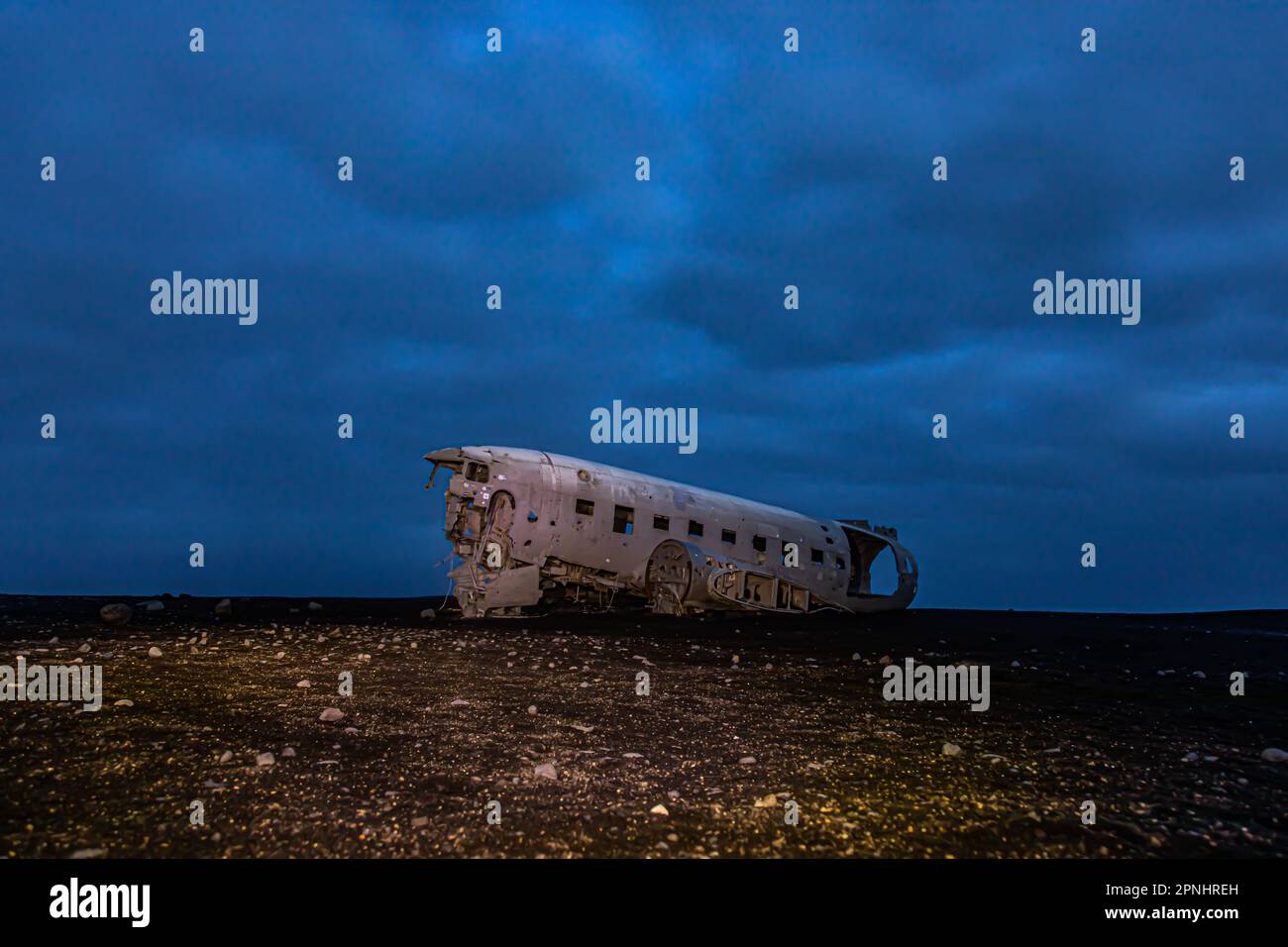 Night view of the old crashed plane wreck abandoned in a remoted black ...
