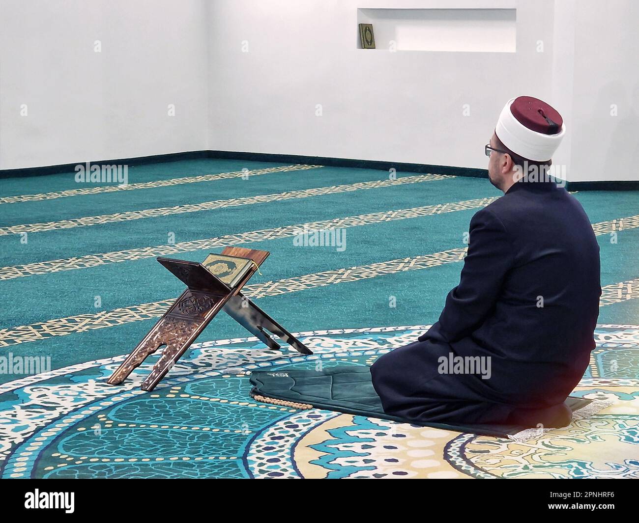 Islam, religion and prayer of a muslim leader or imam at mosque in ...