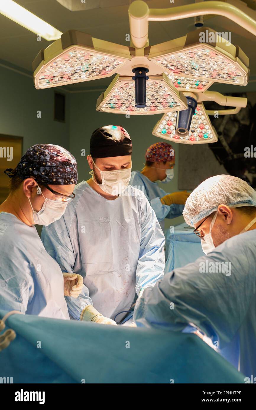 The faces of doctors surgeons in masks are a big plan, an operating ...
