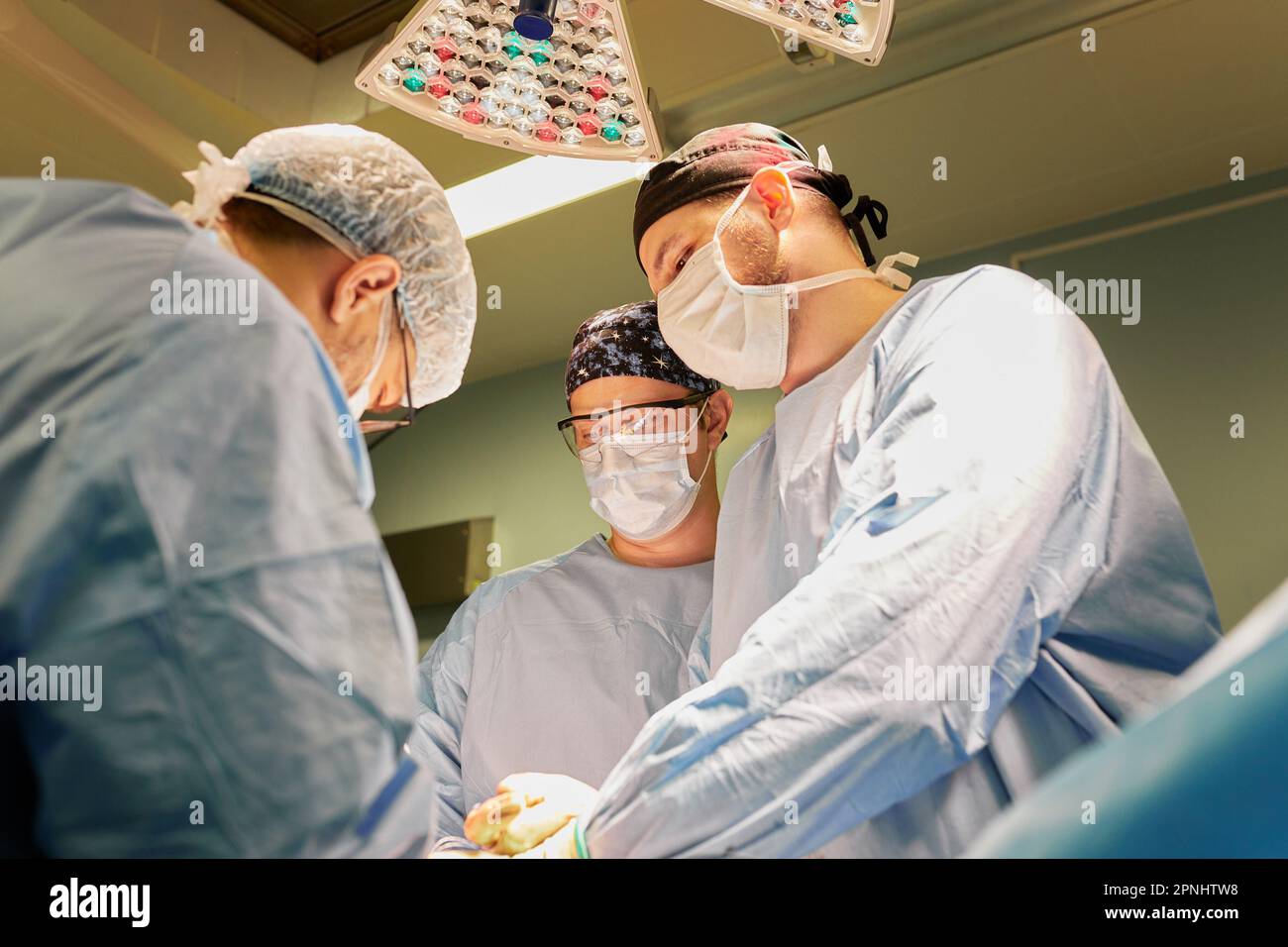The faces of doctors surgeons in masks are a big plan, an operating ...