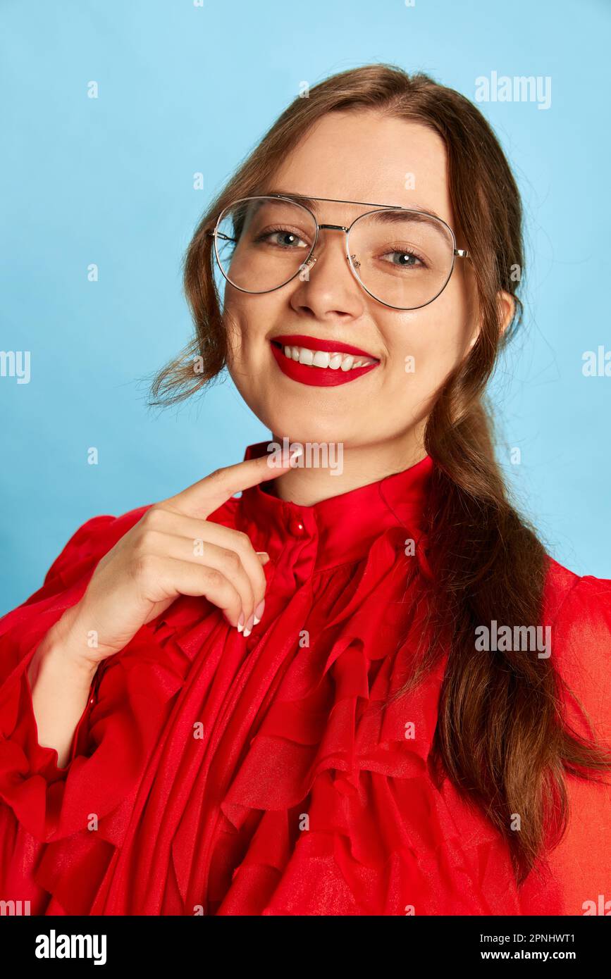 Portrait of amazing woman in chic clothes with red lips touching chin ...