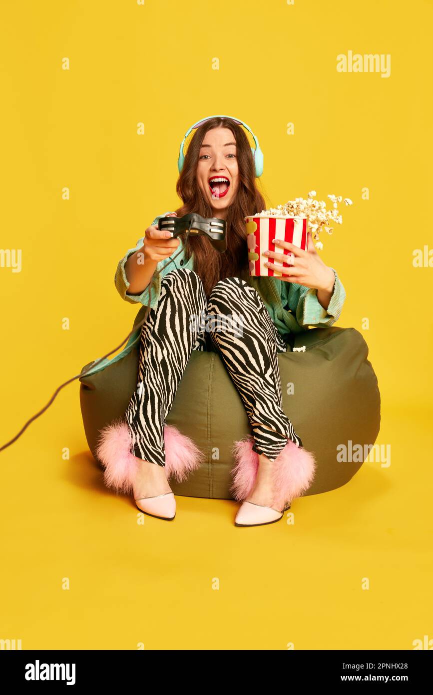 Portrait of young girl, woman holding popcorn and happy to win at ...