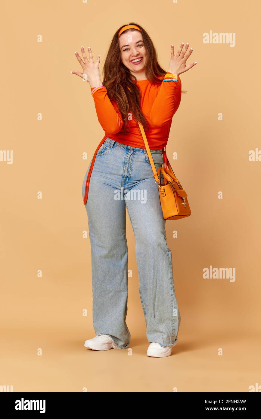 Portrait of adorable girl, student wearing bright clothes and jeans ...