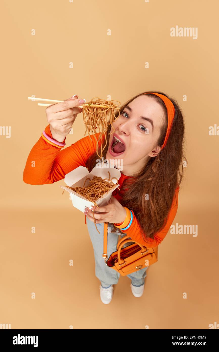 Portrait with young beautiful student, girl holding box with food and ...