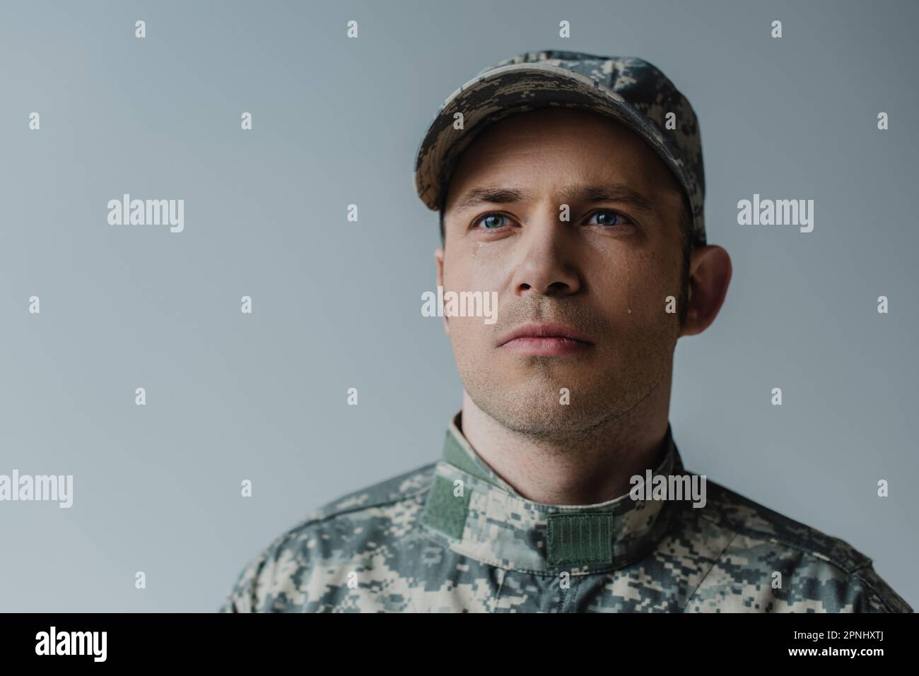 sad military man in uniform crying during memorial day isolated on grey ...