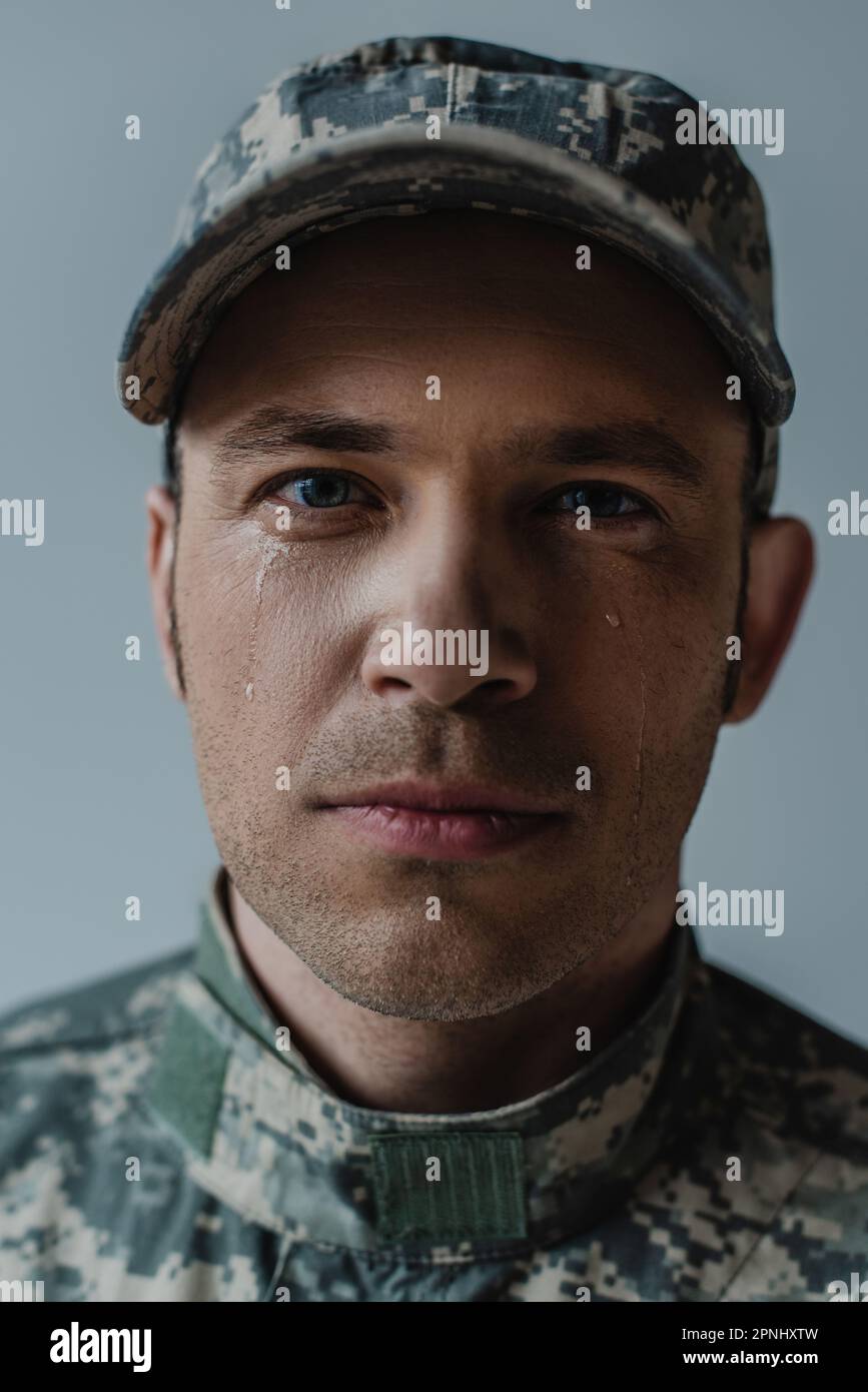 portrait of sad soldier in military uniform crying during memorial day ...