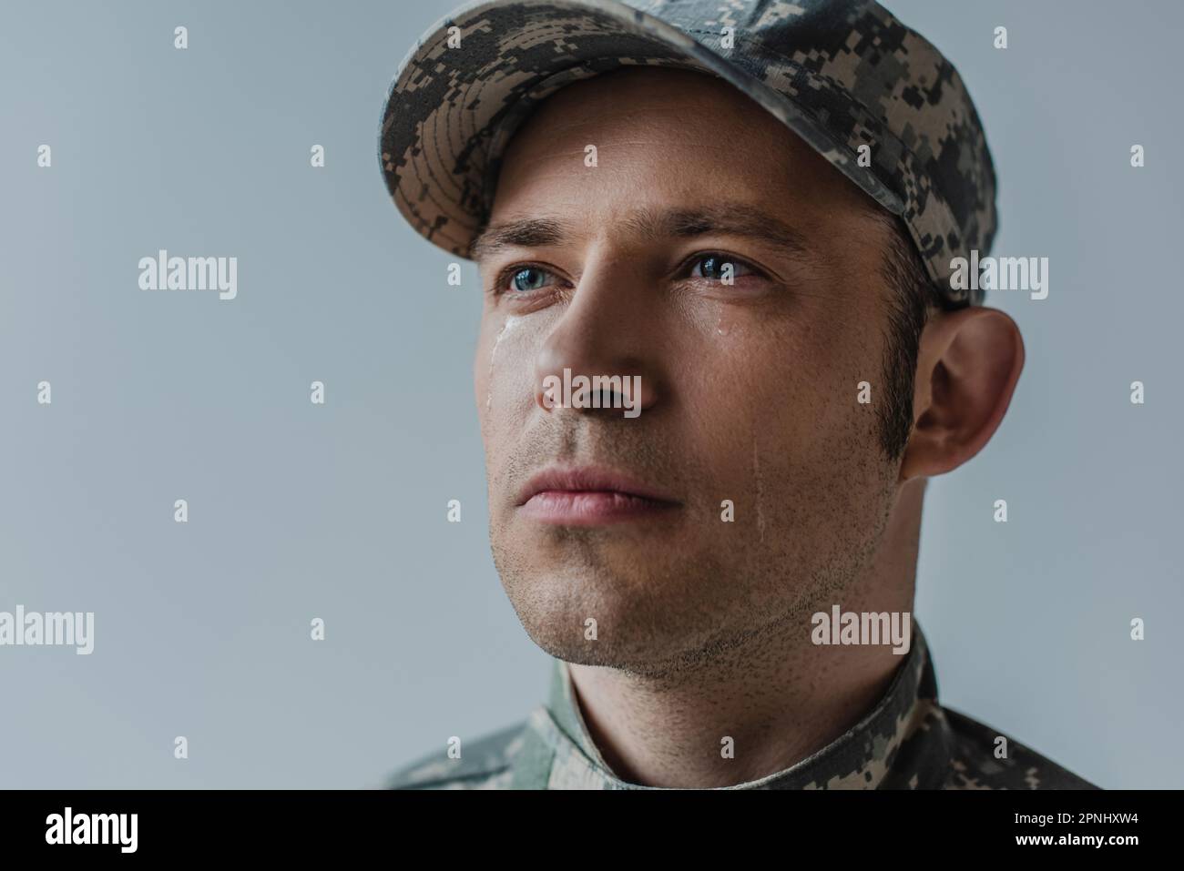 brave soldier in military uniform with teardrop on face isolated on ...