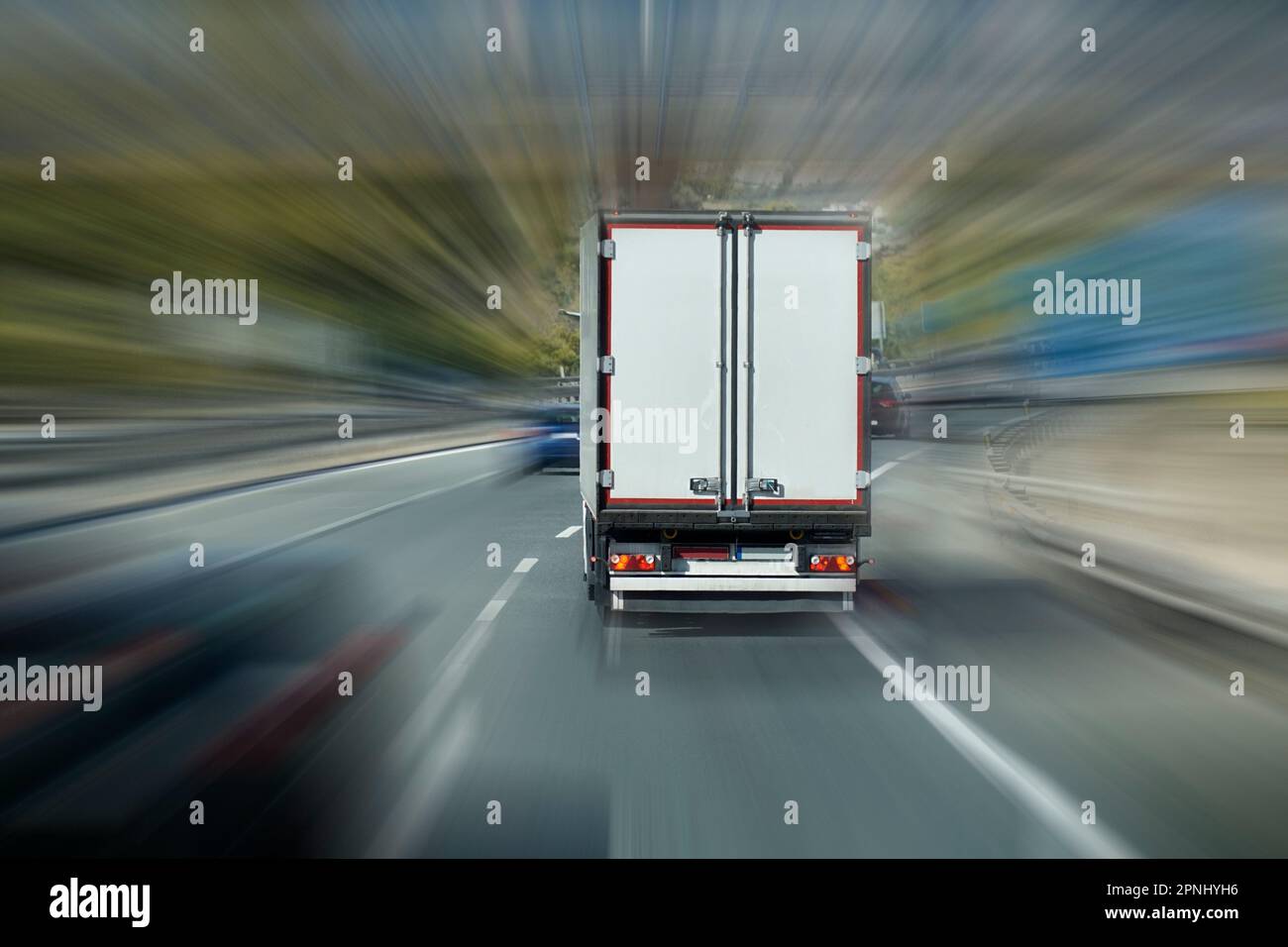 Truck on a highway - back view Stock Photo - Alamy