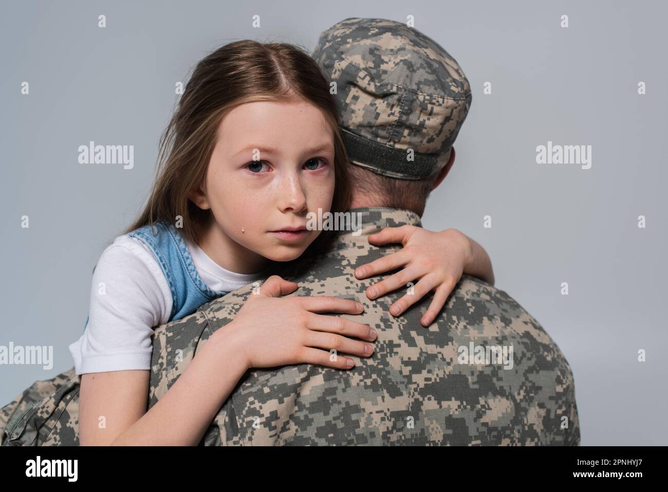 patriotic girl hugging father in army uniform and crying during ...