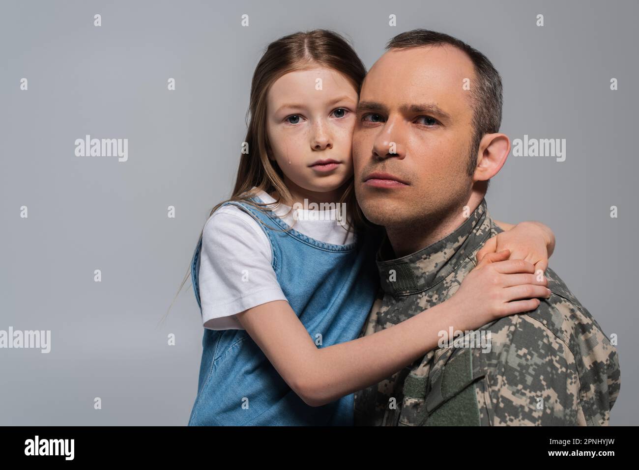 patriotic kid hugging military man in uniform and crying during ...