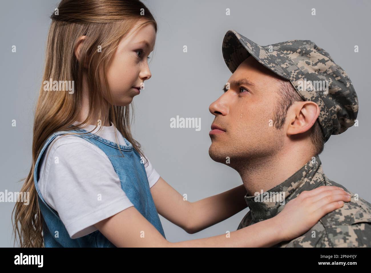 sad girl looking at serviceman in military uniform crying during ...