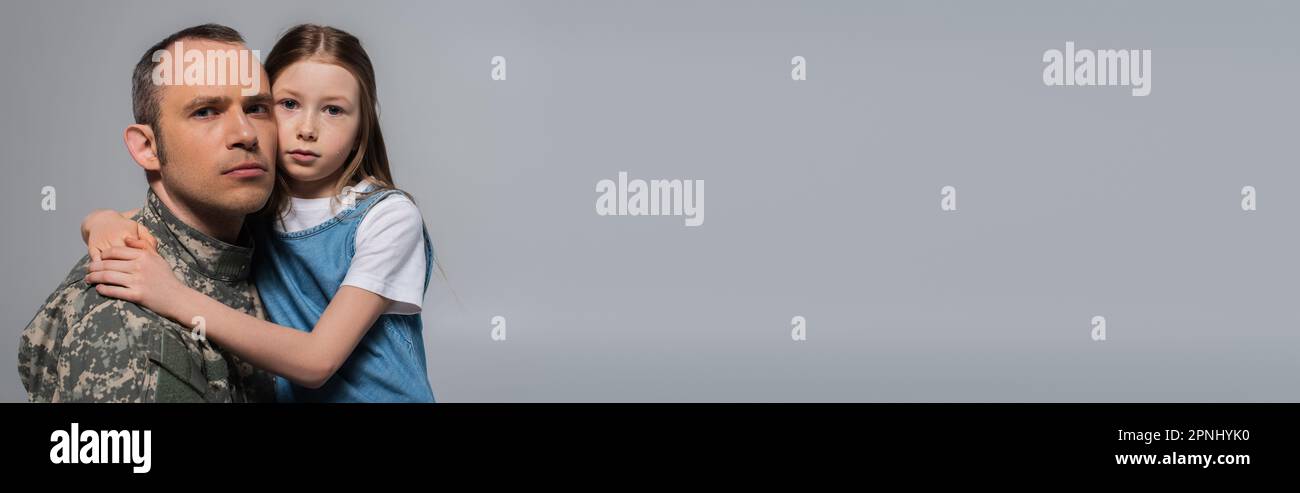 patriotic kid hugging father in uniform and crying during memorial day ...