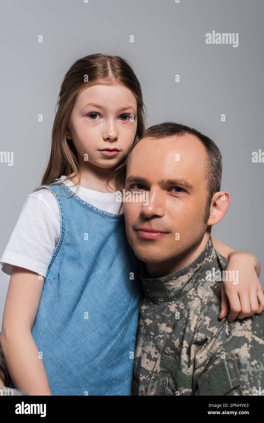 patriotic kid hugging serviceman in army uniform and crying during ...