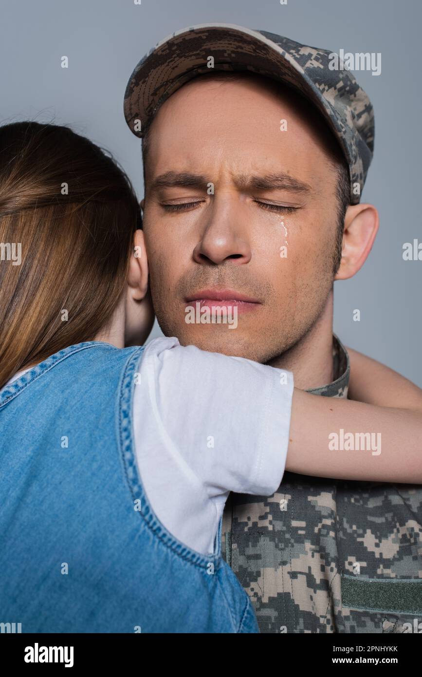 sentimental serviceman in military uniform crying and hugging with ...