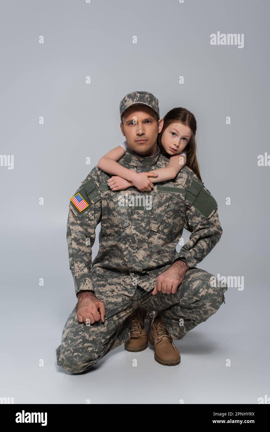 preteen kid hugging brave father in army uniform during memorial day on ...