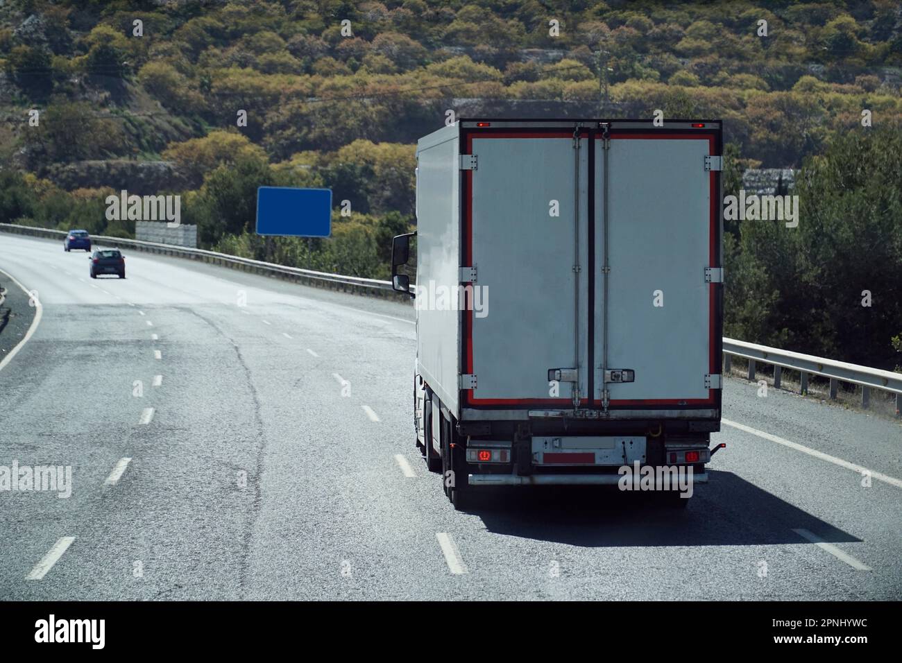 Truck on a highway - back view Stock Photo - Alamy