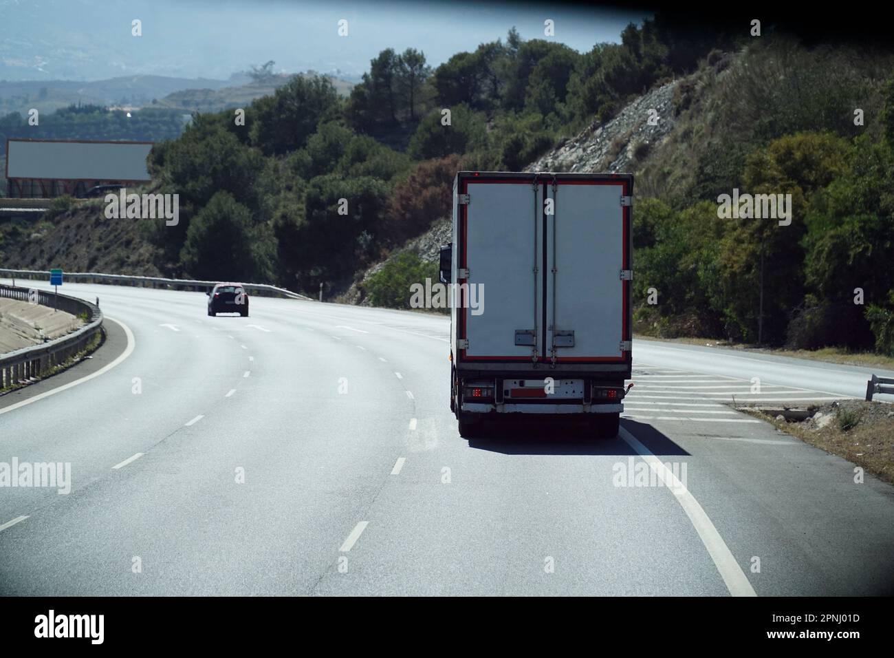 Truck on a highway - back view Stock Photo - Alamy