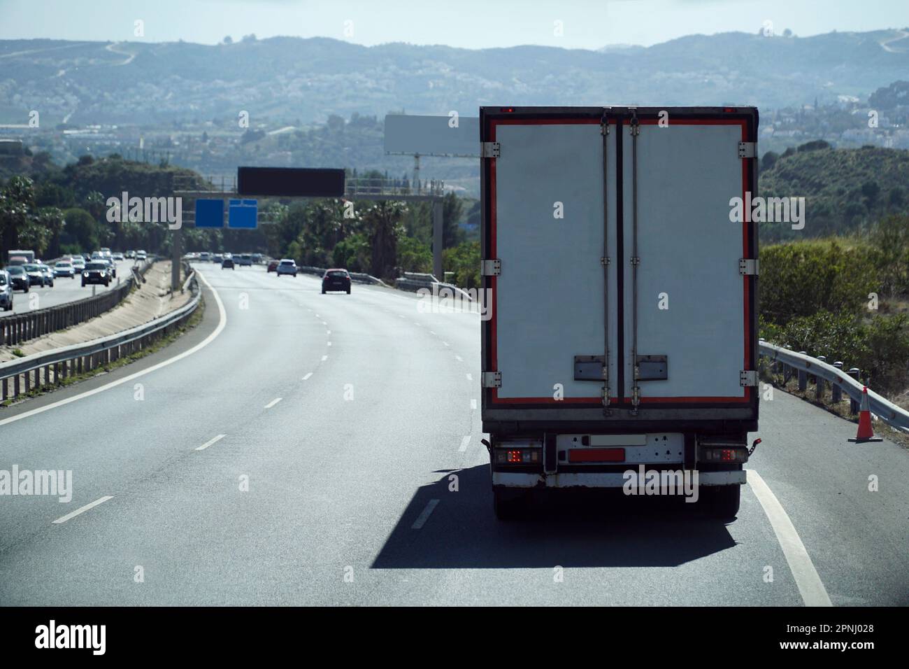 Truck on a highway - back view Stock Photo - Alamy