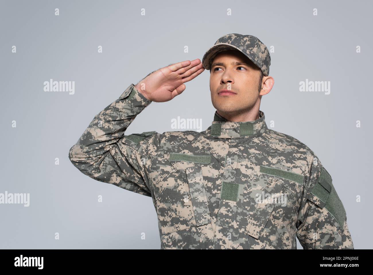 American patriot in military uniform with cap saluting during memorial ...
