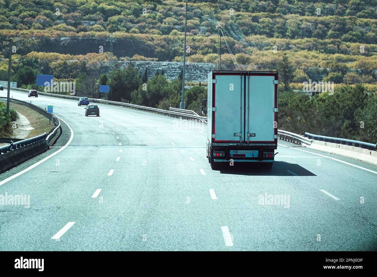 Truck on a highway - back view Stock Photo - Alamy